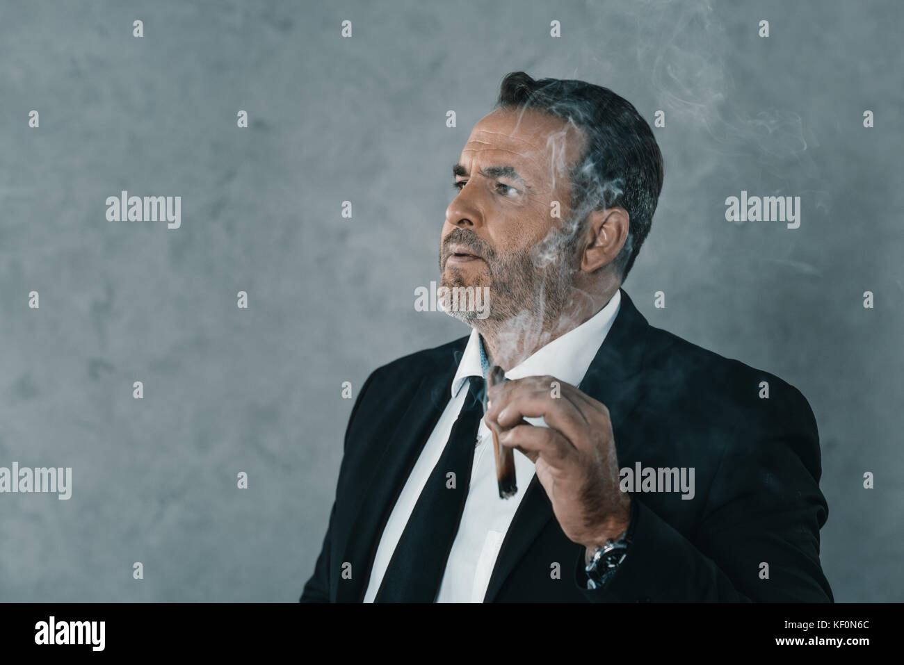 businessman smoking cigar Stock Photo - Alamy