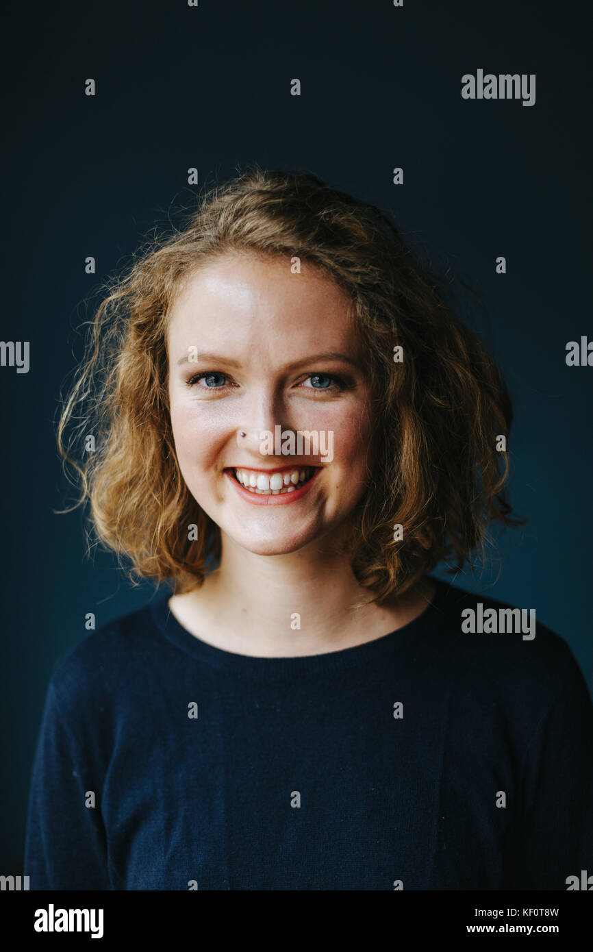 Young blonde woman sitting indoors hi-res stock photography and images - Alamy