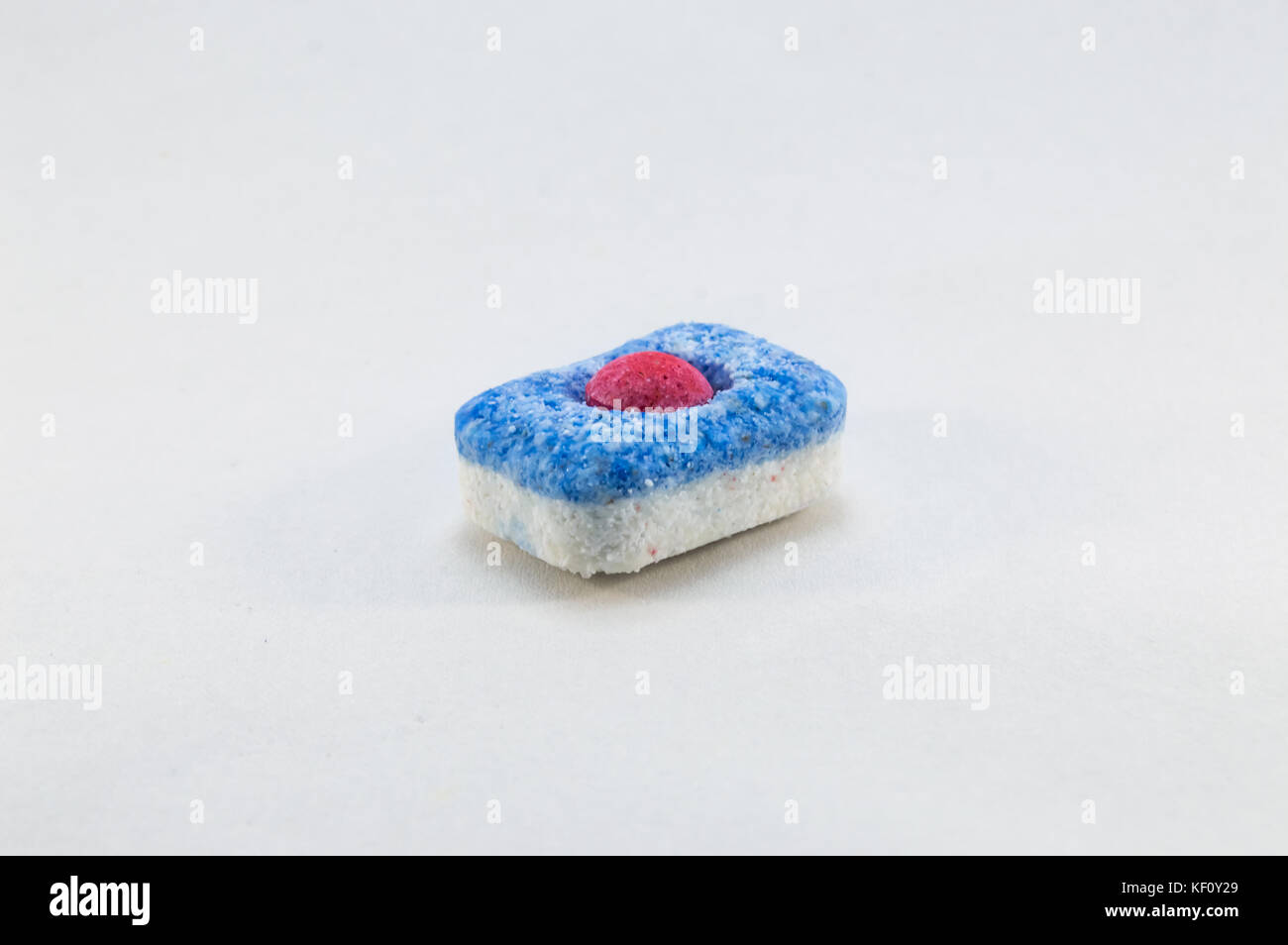 Dishwasher tablet with center of red color on a white background Stock ...