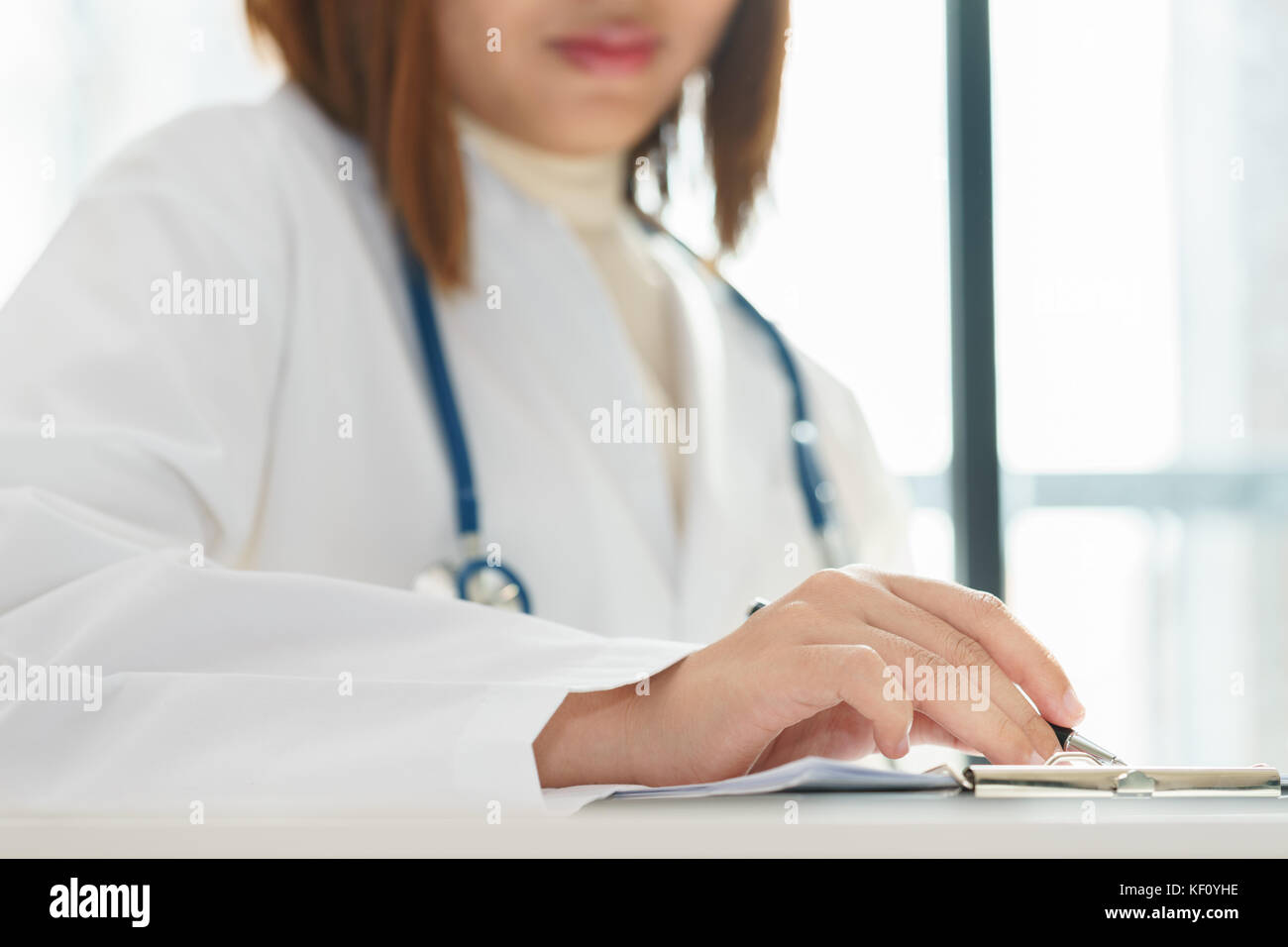 Doctor writing about her patient disease in paper, medical diagnosis ...