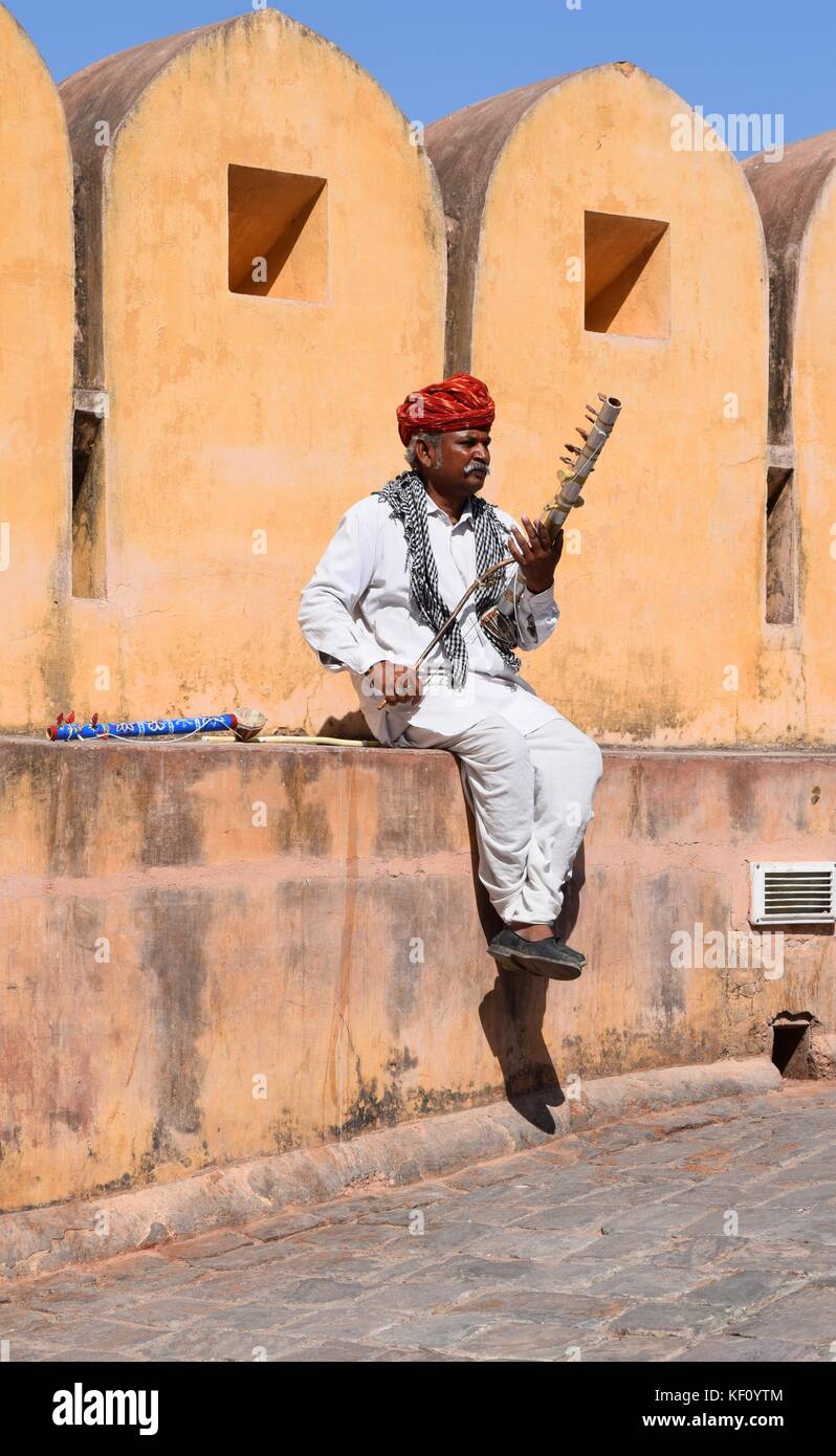 Basking in the desert sun of Rajasthan, sits an artist playing the ...