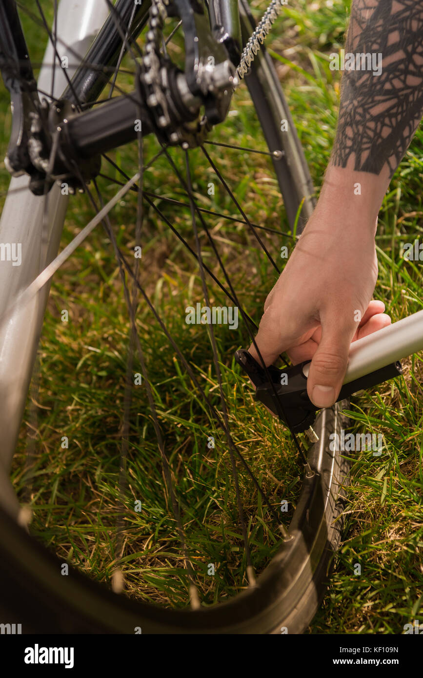 man pumping bicycle wheel Stock Photo - Alamy