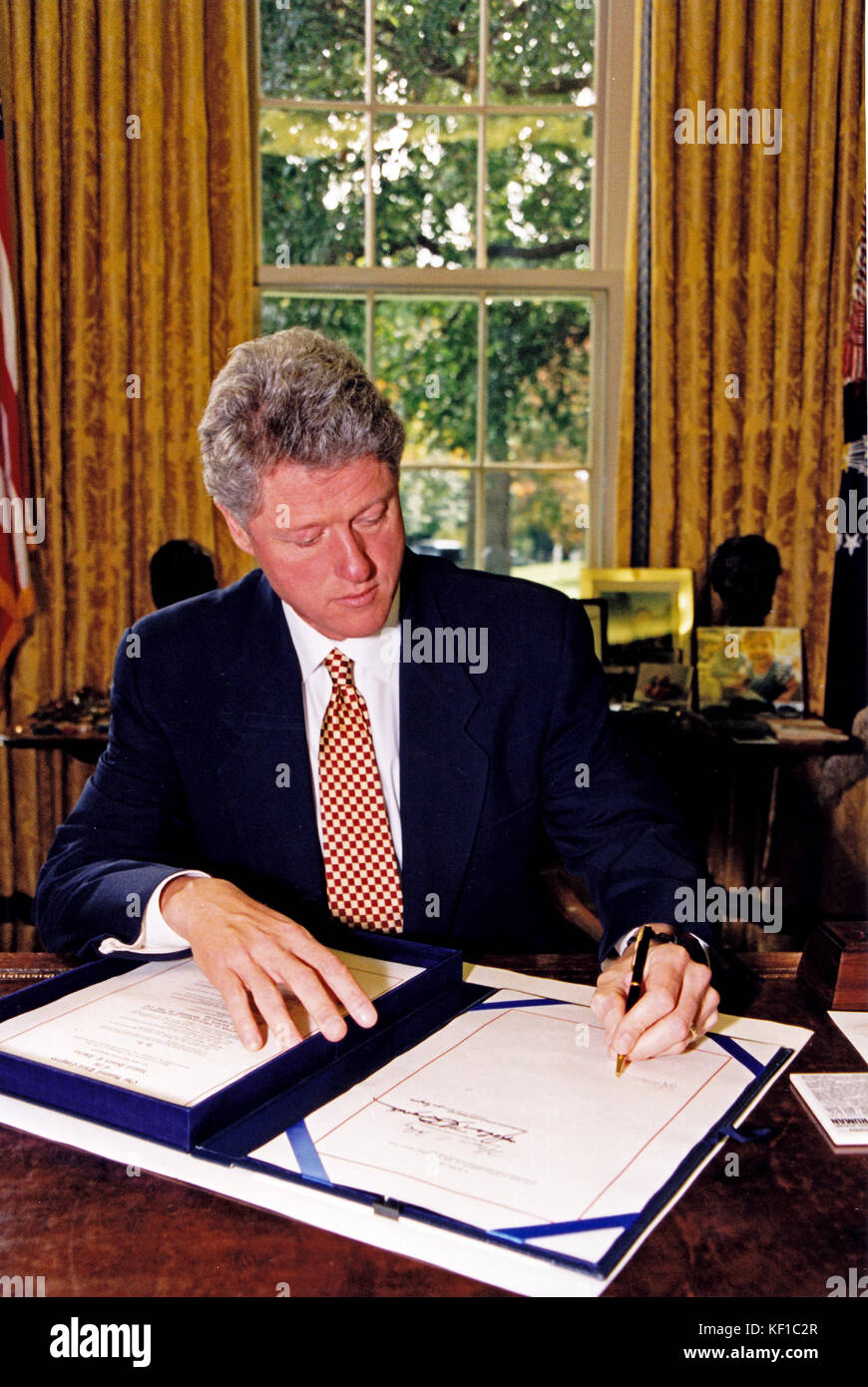 United States President Bill Clinton signs the Uniformed Services ...