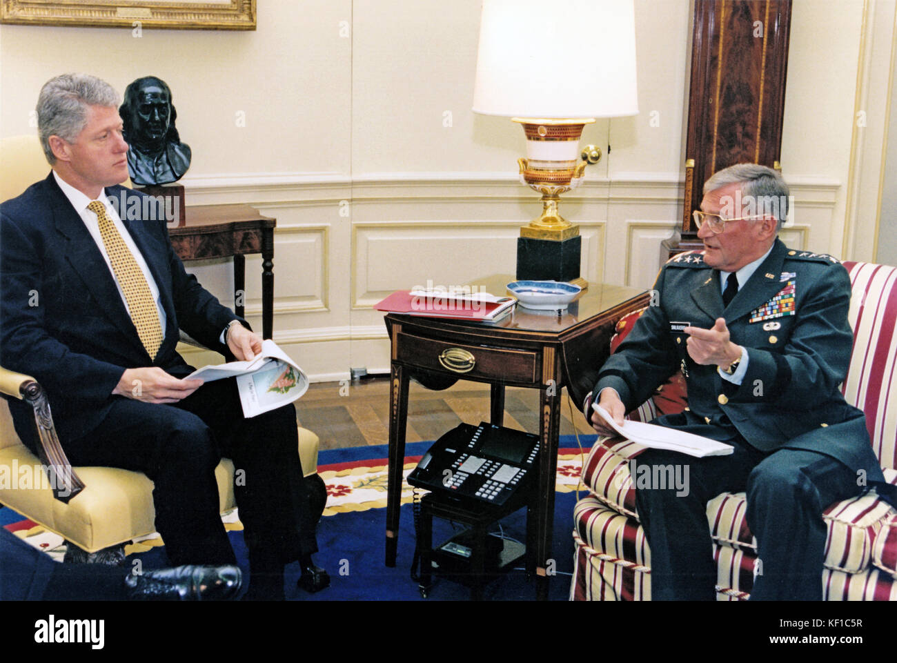 United States President Bill Clinton receives a briefing from the ...