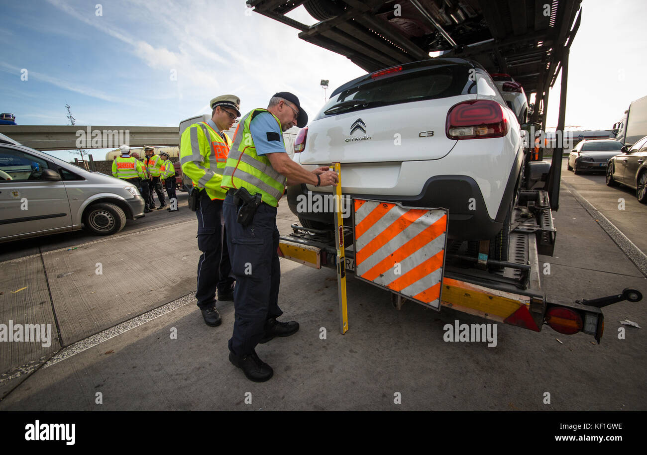 Police and customs officers inspecting the loading of a trailer truck ...