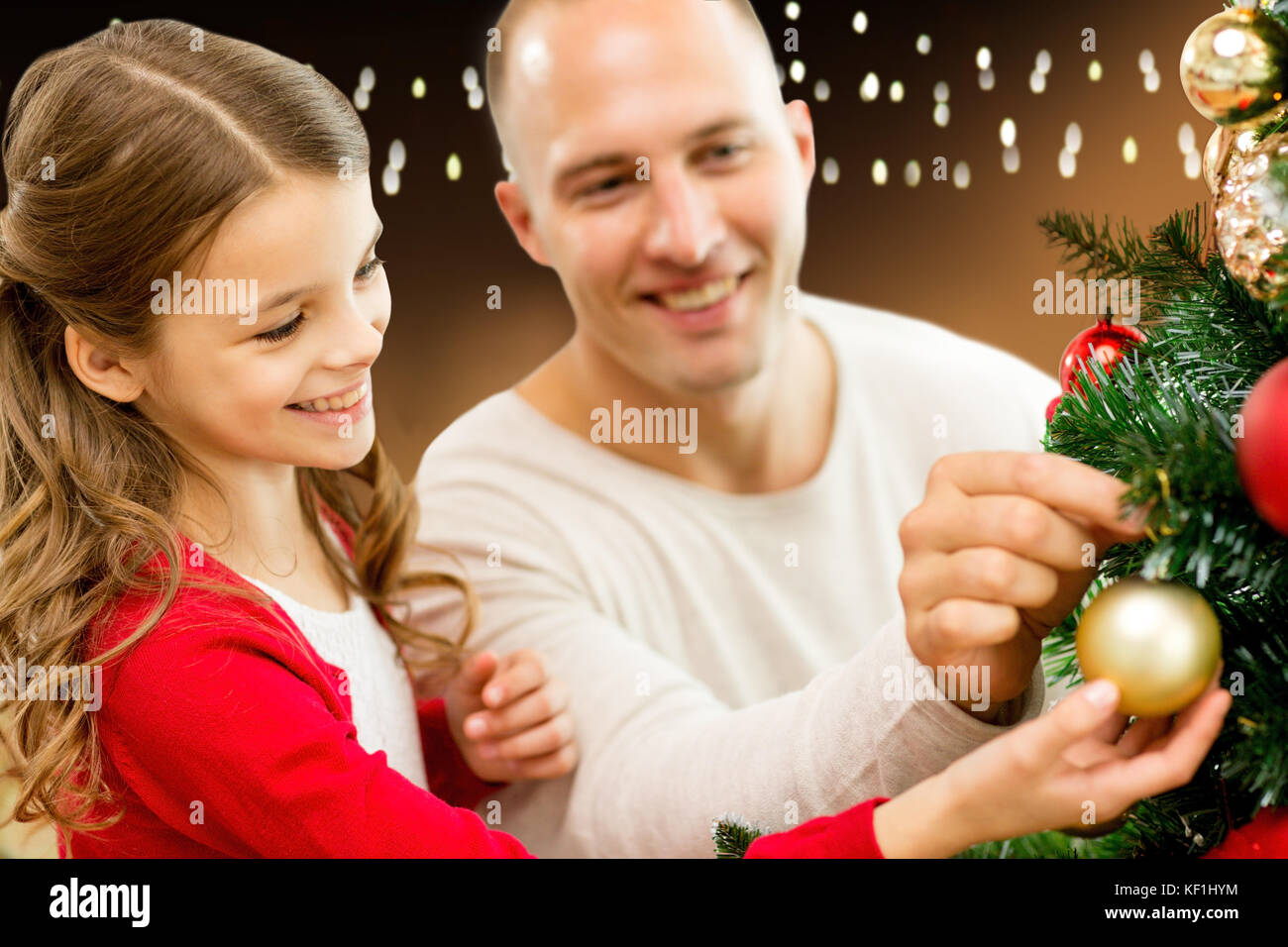 happy family decorating christmas tree at home Stock Photo - Alamy