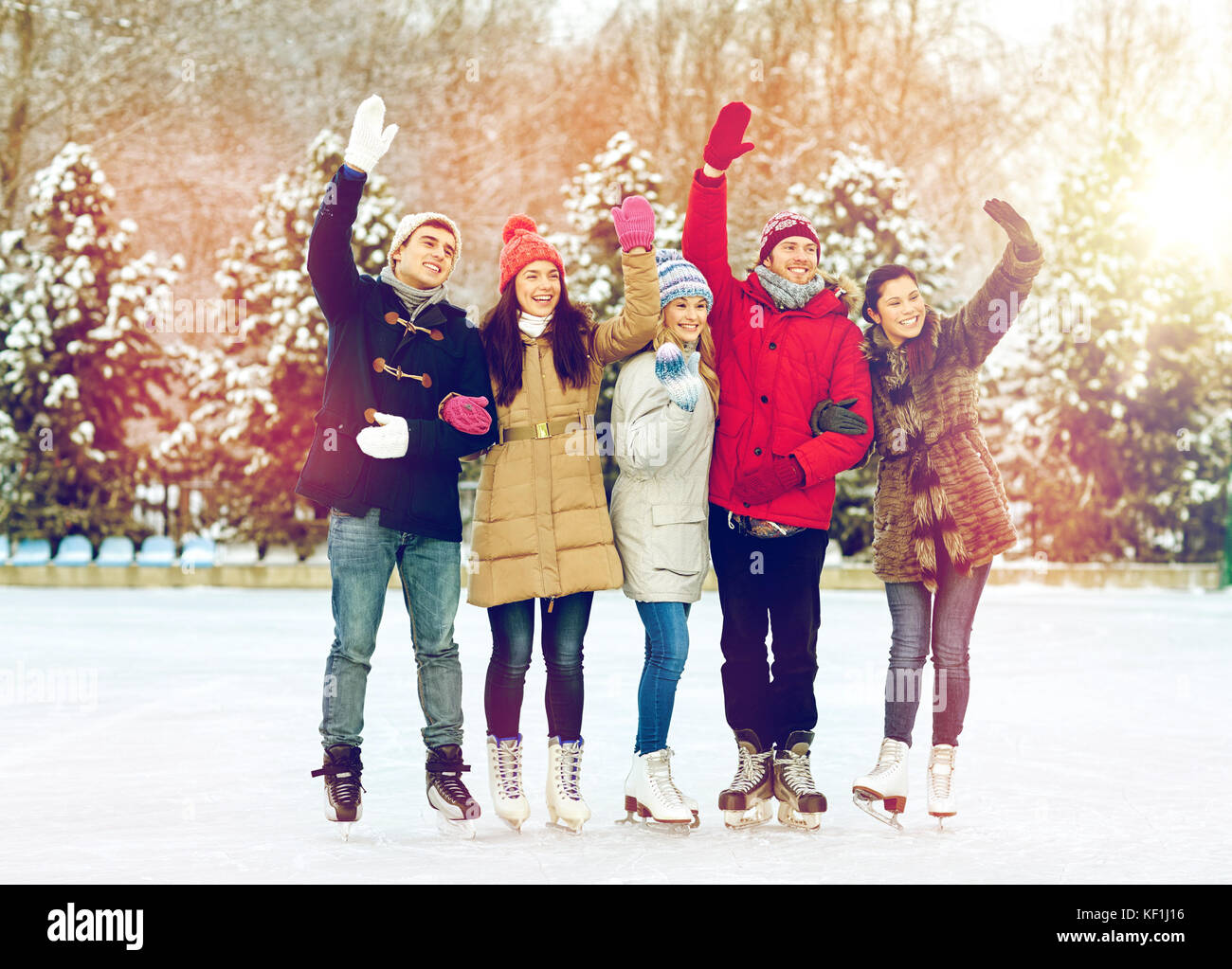 happy friends ice skating on rink outdoors Stock Photo - Alamy