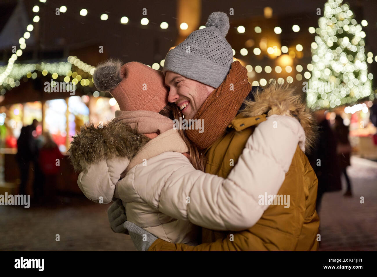 happy couple hugging at christmas tree Stock Photo - Alamy