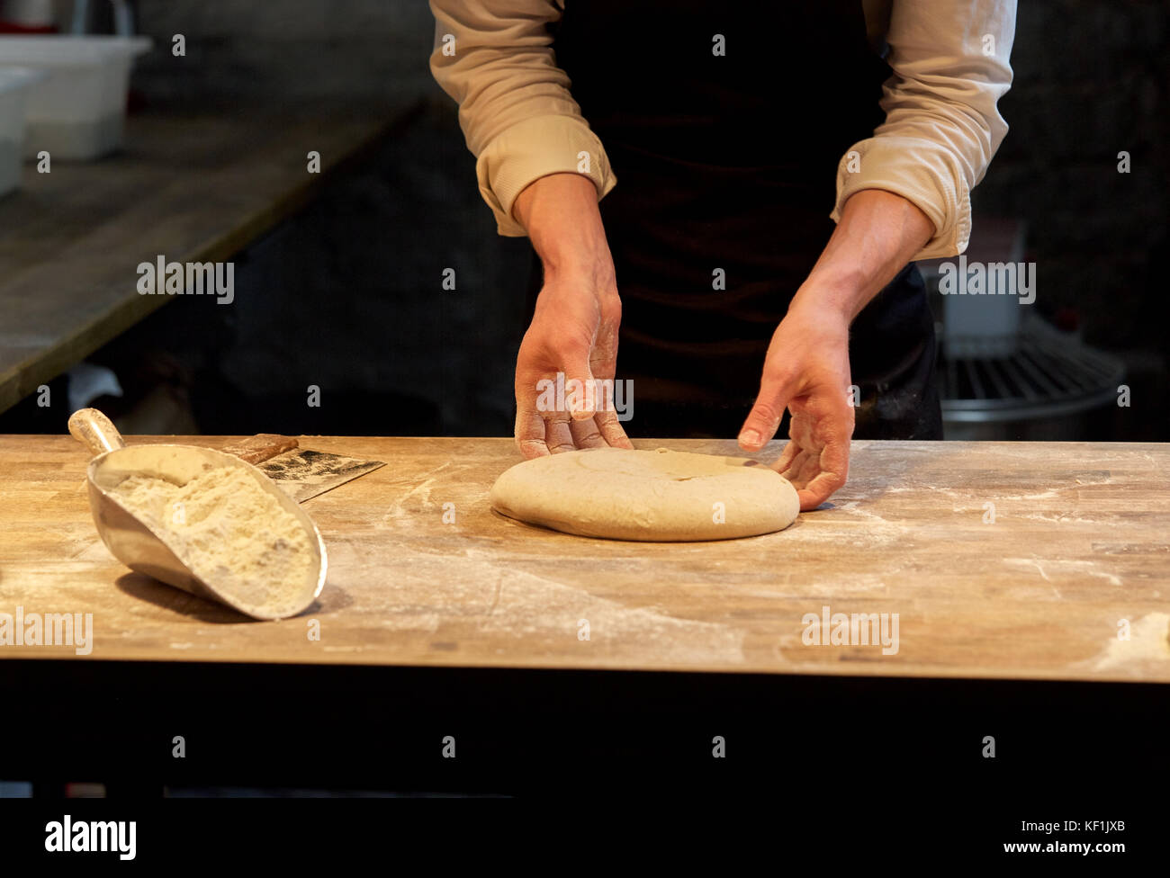 chef or baker cooking dough at bakery Stock Photo - Alamy