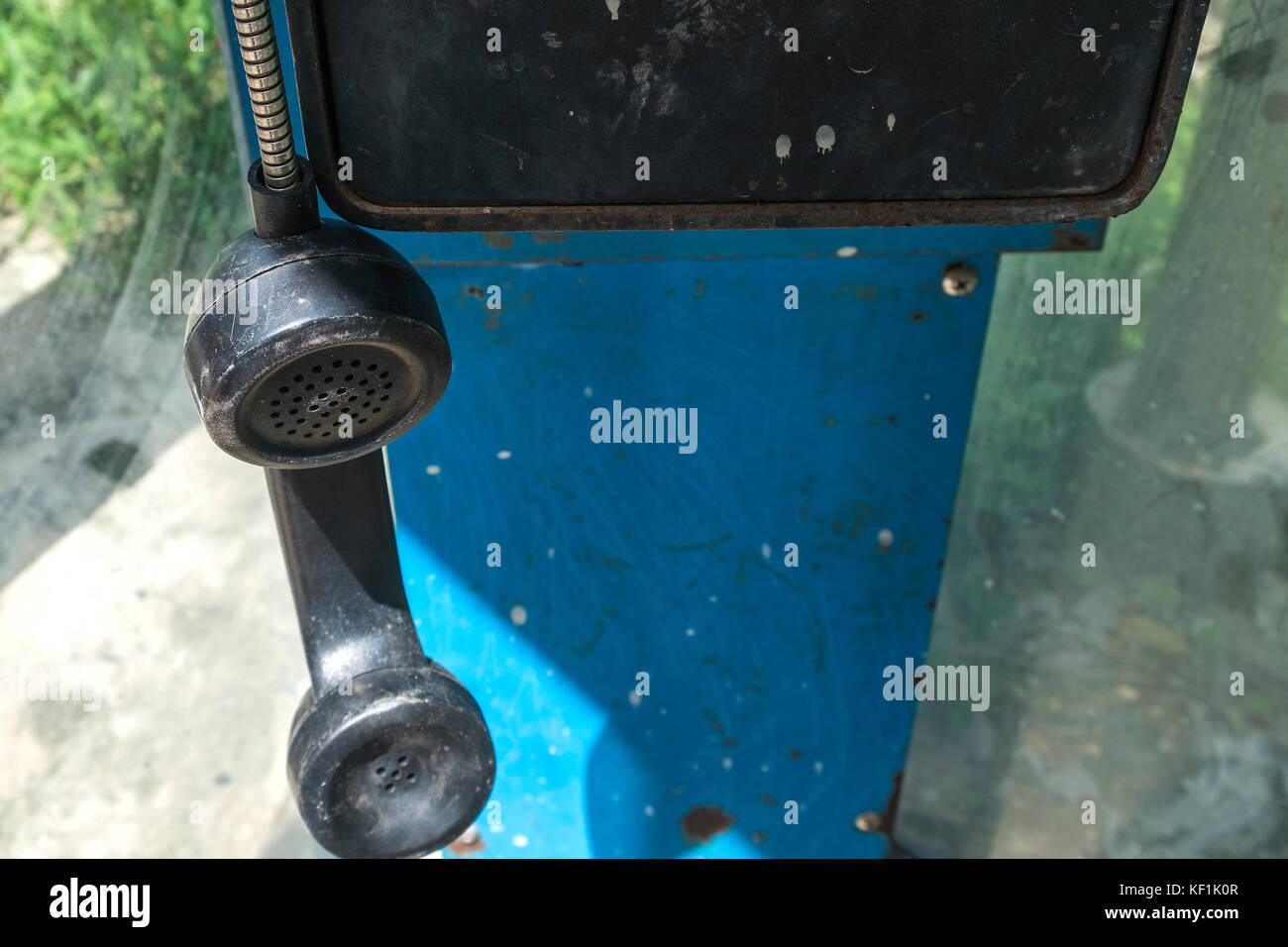 Hanging old phone receiver in old phone booth Stock Photo - Alamy