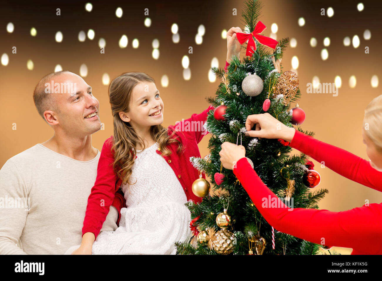 happy family decorating christmas tree at home Stock Photo - Alamy