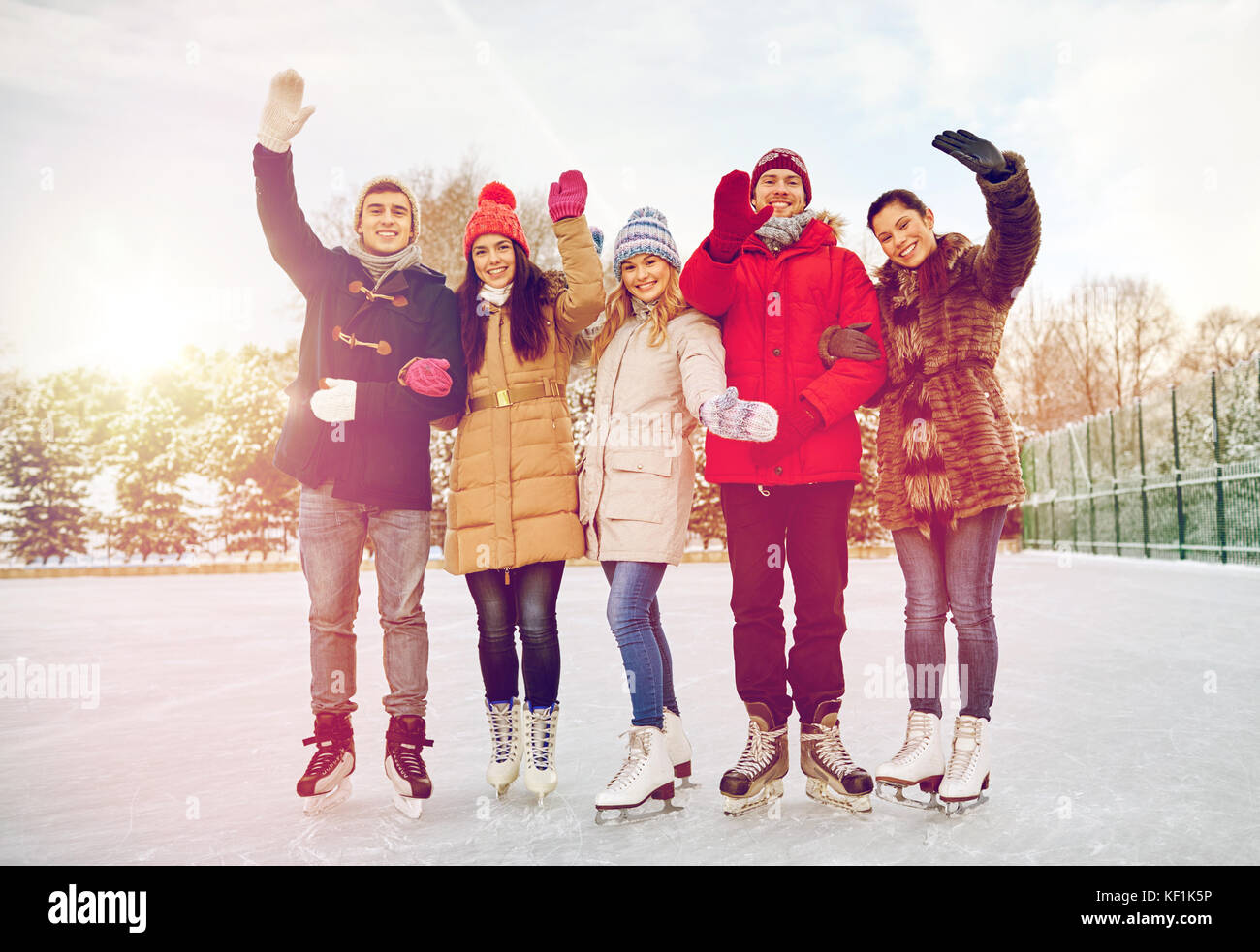 happy friends ice skating on rink outdoors Stock Photo - Alamy