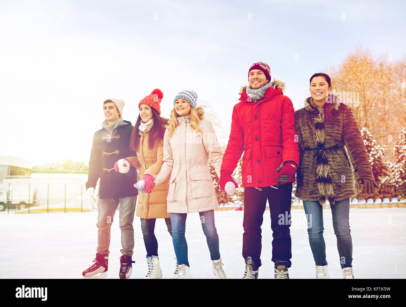 happy friends ice skating on rink outdoors Stock Photo - Alamy