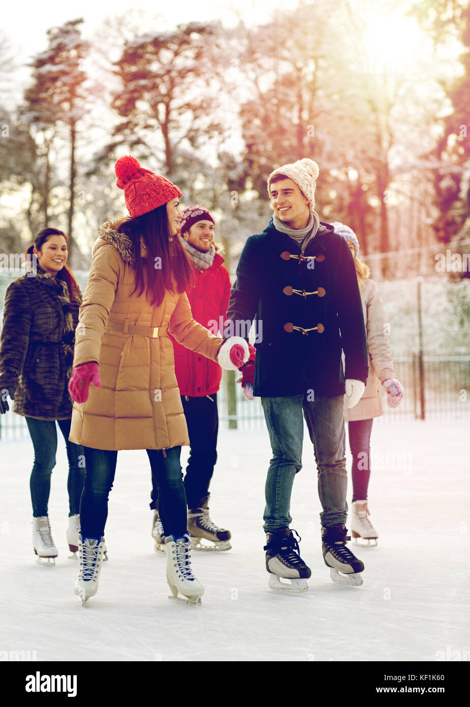 happy friends ice skating on rink outdoors Stock Photo - Alamy