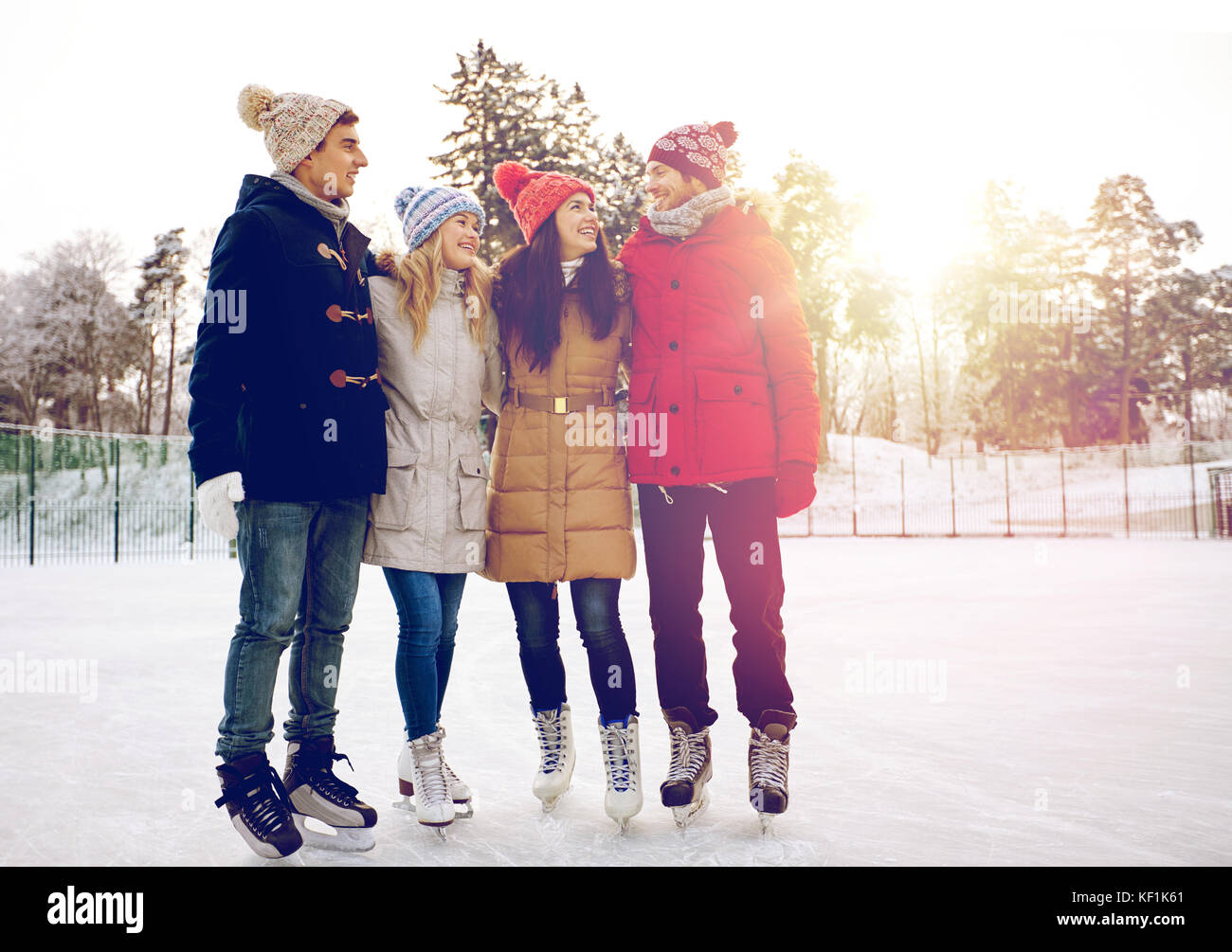 happy friends ice skating on rink outdoors Stock Photo - Alamy