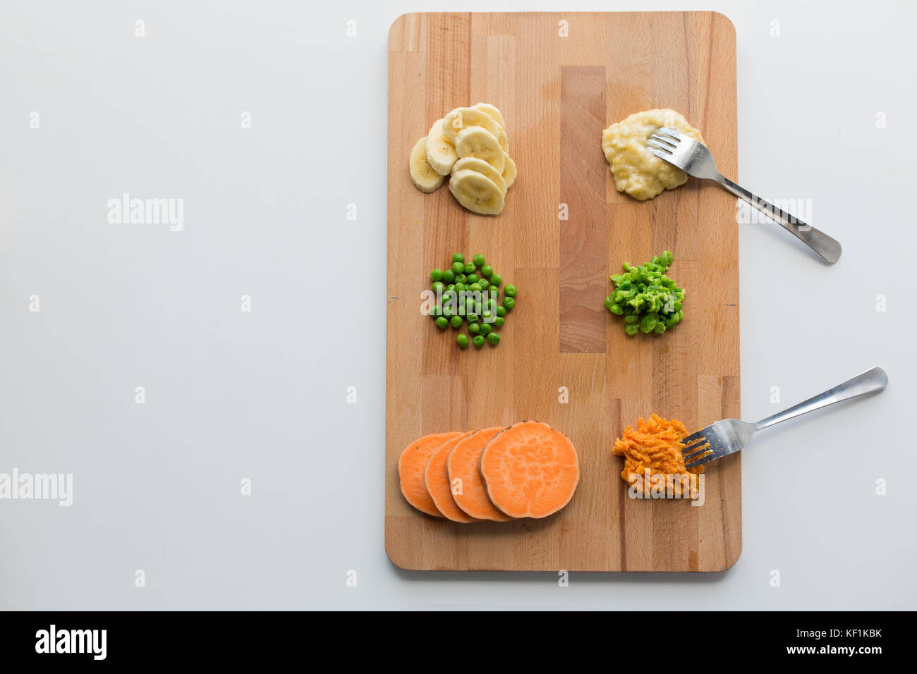 mashed fruits and vegetables with forks on board Stock Photo - Alamy