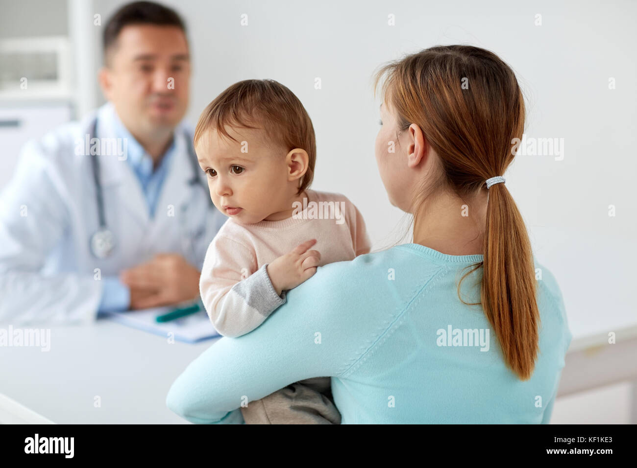 happy woman with baby and doctor at clinic Stock Photo - Alamy