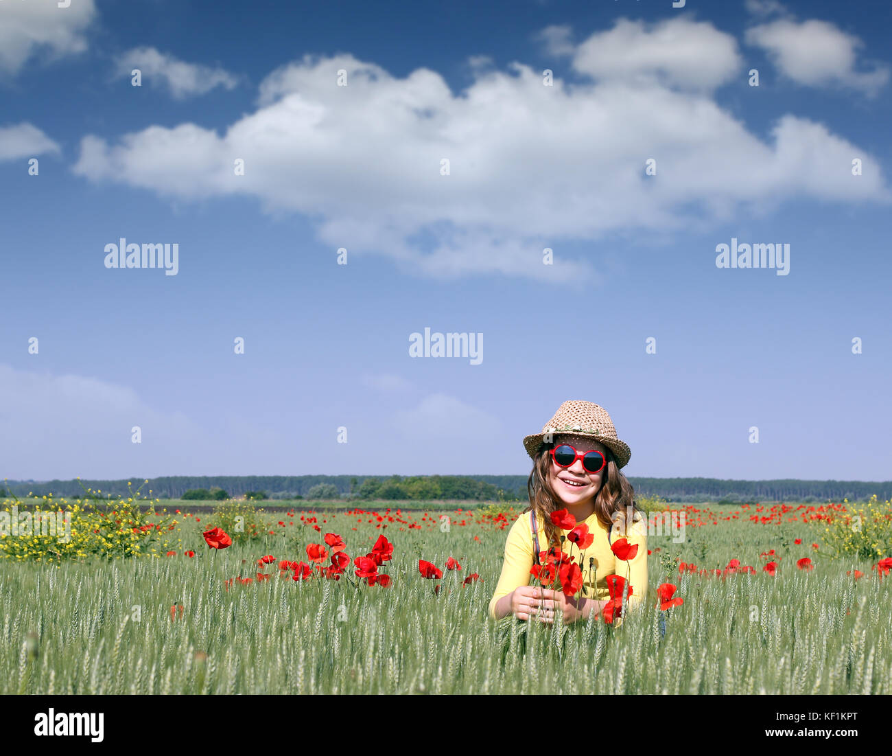 happy little girl with poppies flower on meadow Stock Photo - Alamy