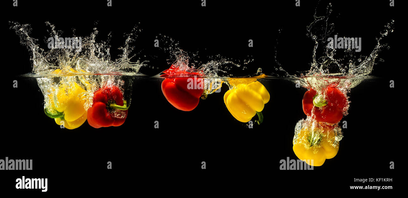 Group of bell pepper falling in water Stock Photo - Alamy