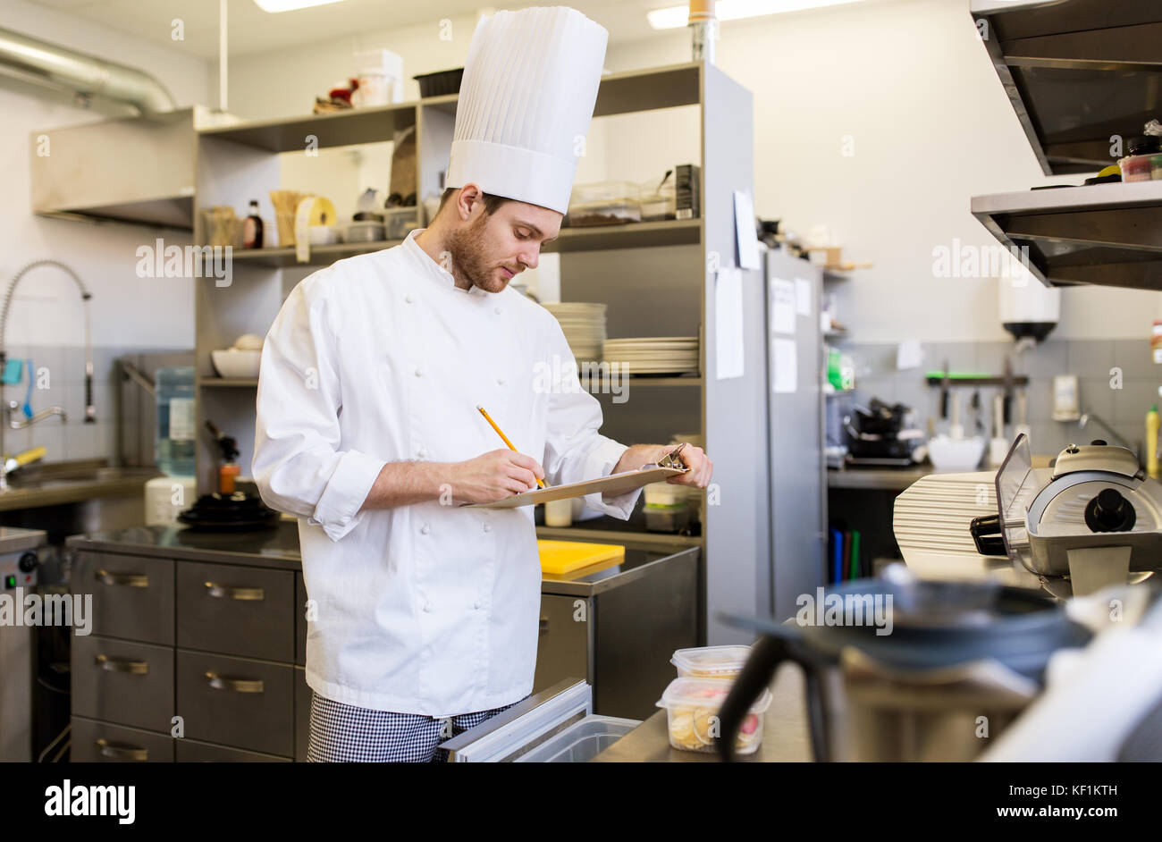 chef with clipboard doing inventory at kitchen Stock Photo - Alamy