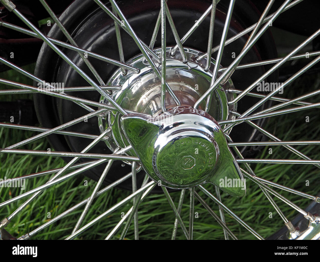 detail of classic car showing chrome hub and spokes of wire wheel of MG ...