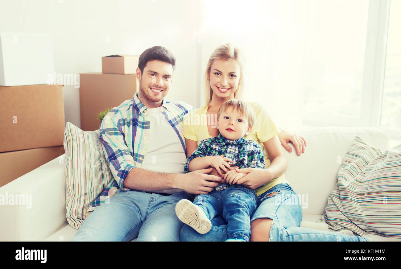 happy family with boxes moving to new home Stock Photo - Alamy