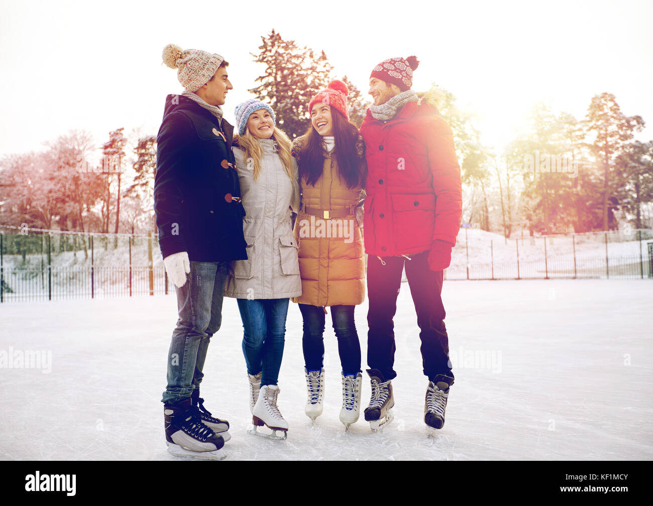 happy friends ice skating on rink outdoors Stock Photo - Alamy