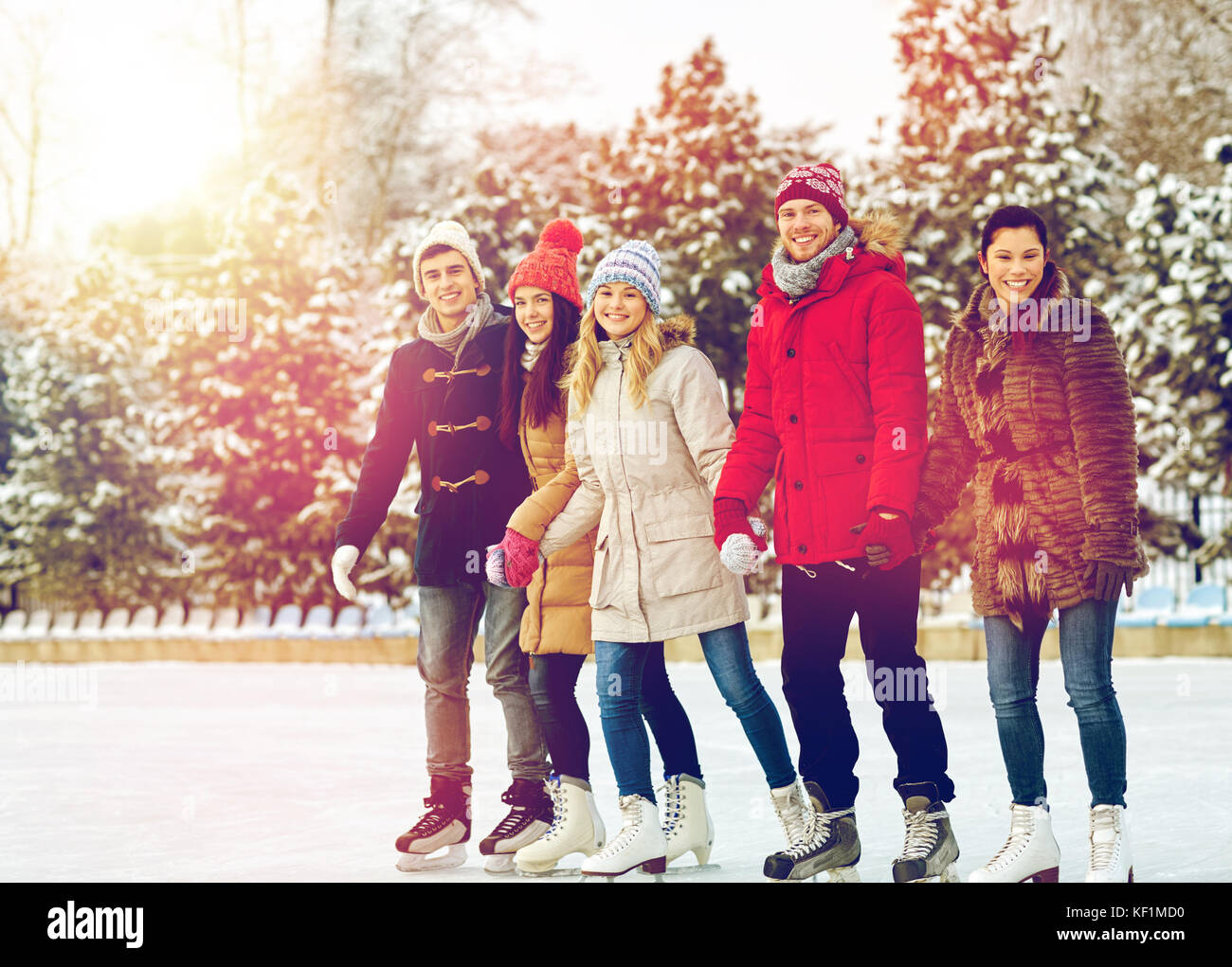 happy friends ice skating on rink outdoors Stock Photo - Alamy