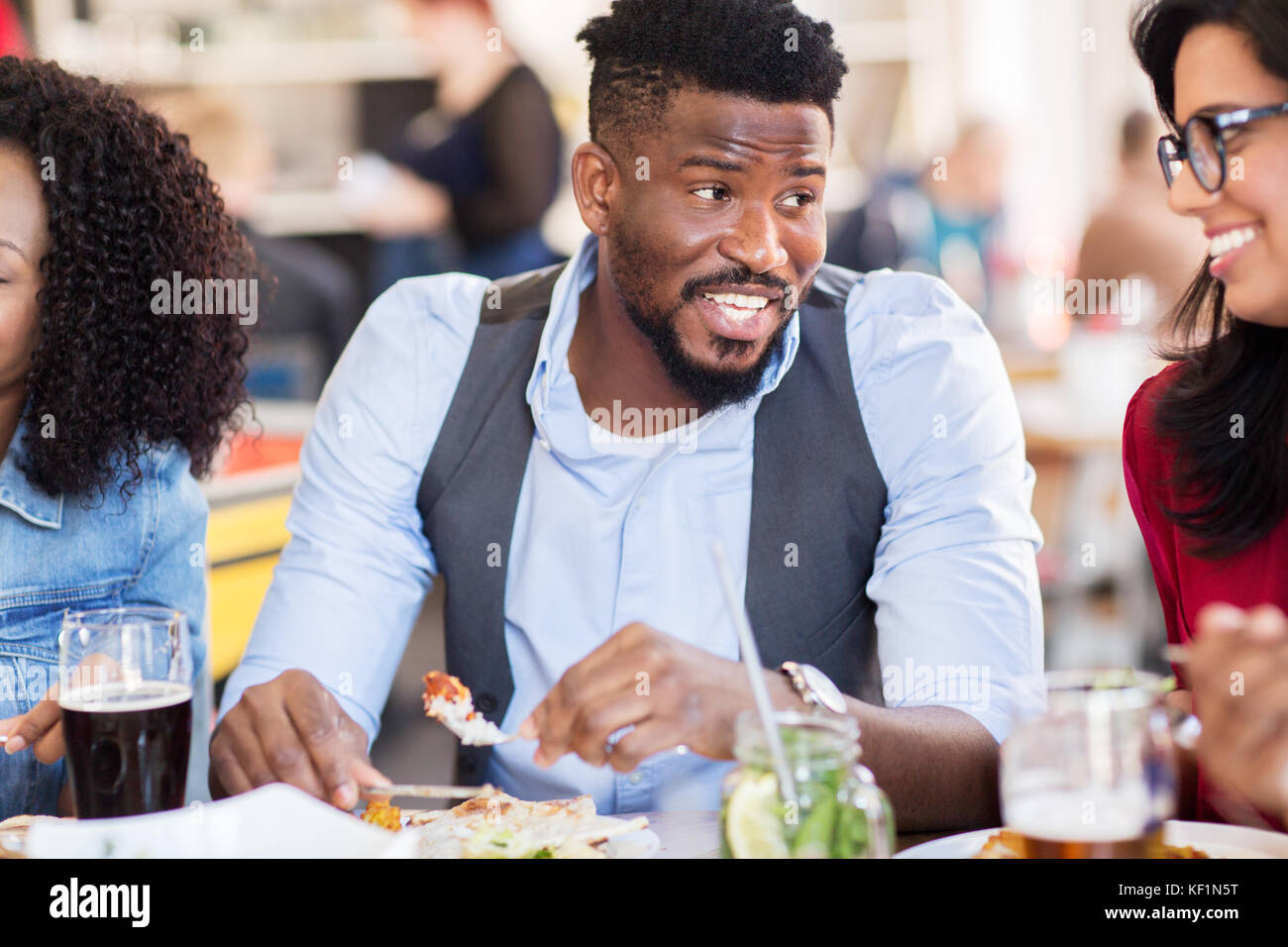 happy friends eating at restaurant Stock Photo - Alamy
