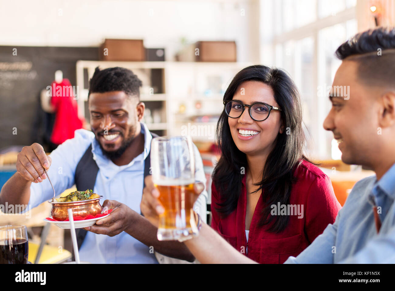 happy friends eating at restaurant Stock Photo - Alamy
