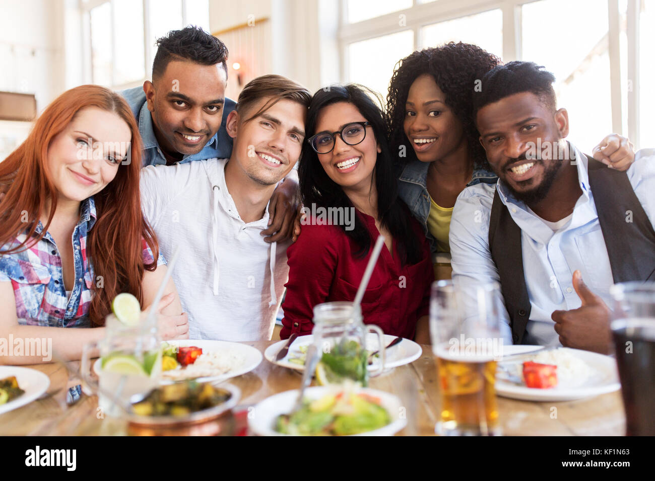 happy friends eating at restaurant Stock Photo - Alamy