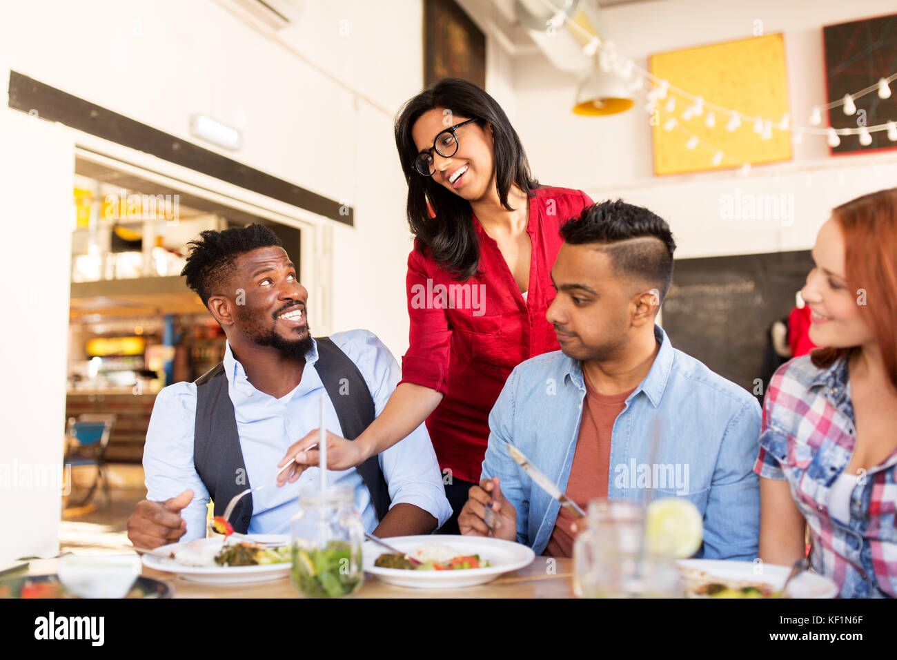 happy friends eating at restaurant Stock Photo - Alamy