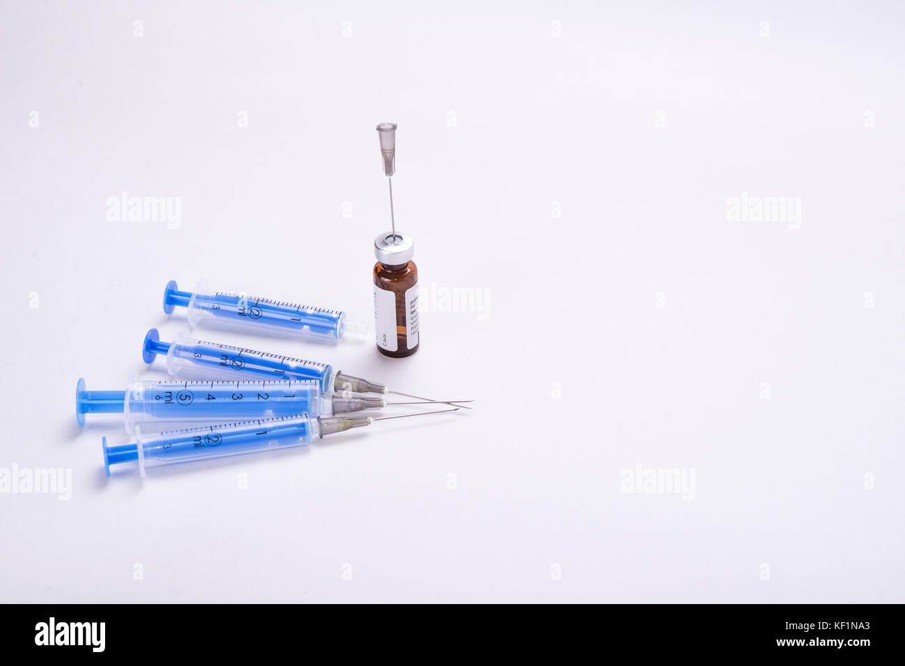 Four shots with needles ready to fill up on the white background Stock ...