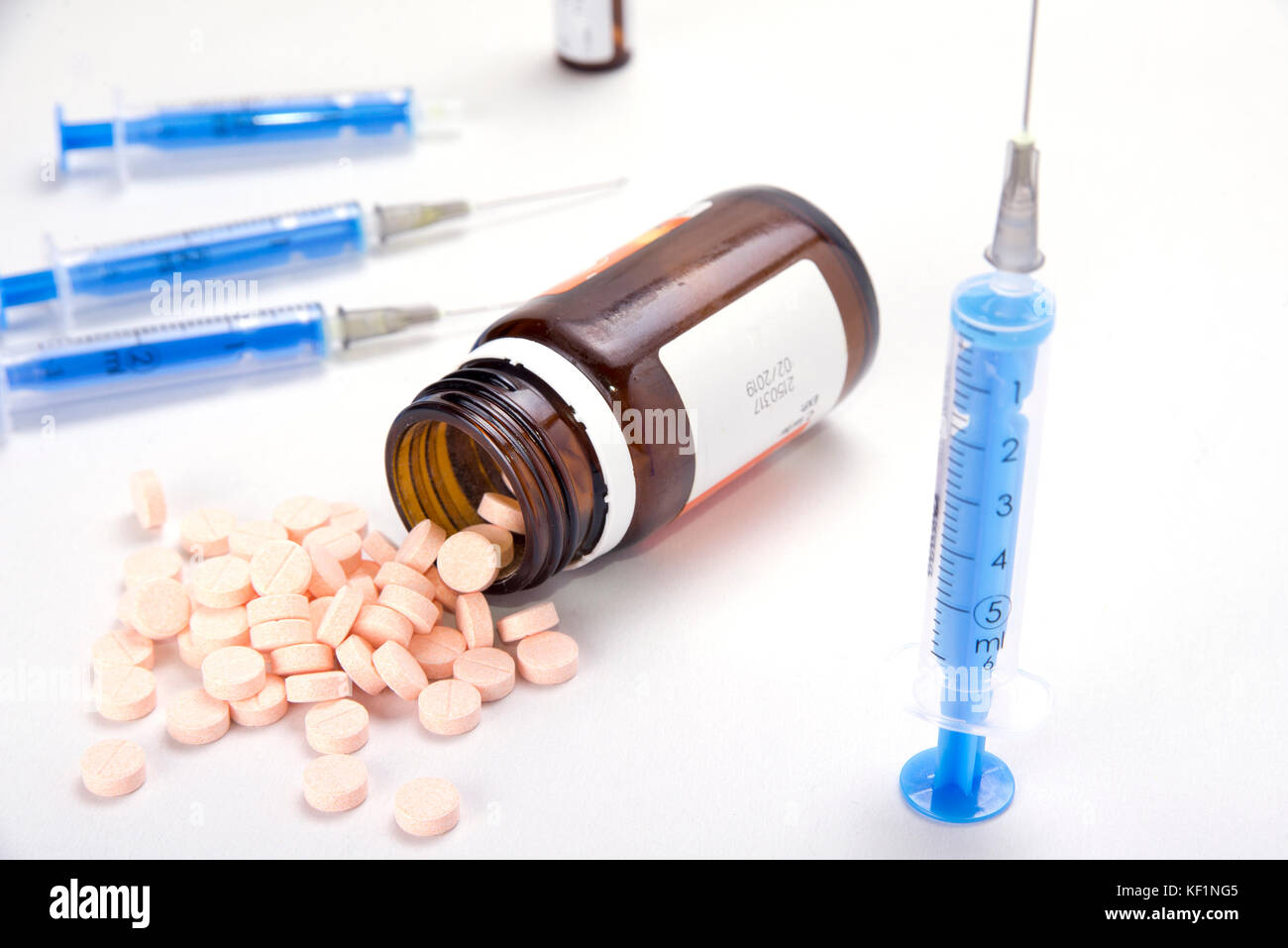 Spilled pills and shots with needles on the withe background Stock ...