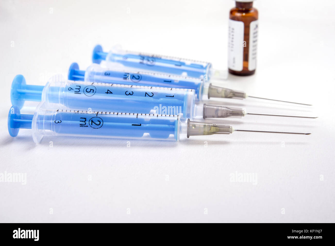 Four injections with needles on the white background Stock Photo - Alamy