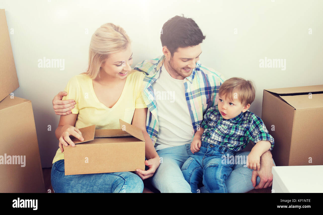 happy family with boxes moving to new home Stock Photo - Alamy