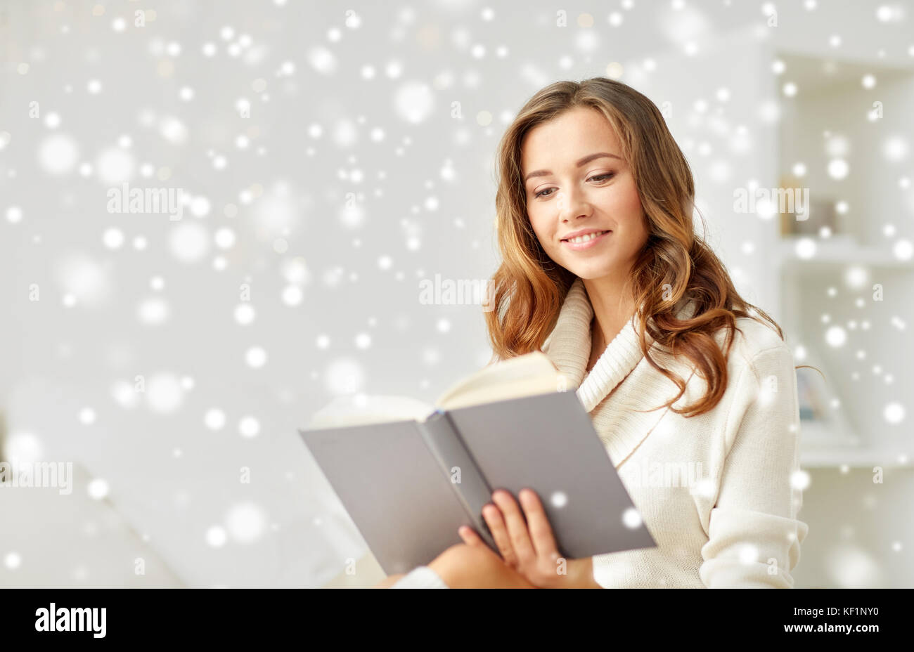 happy young woman reading book at home Stock Photo - Alamy