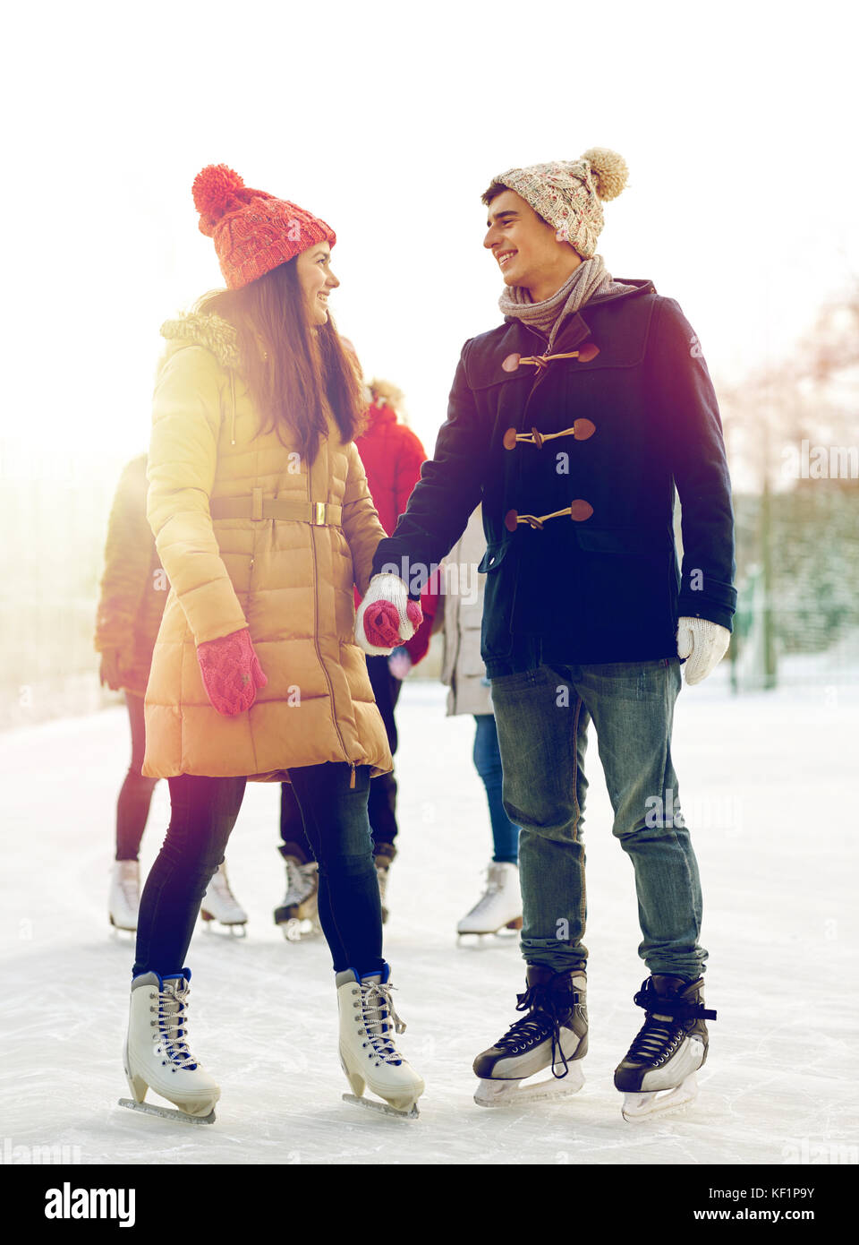 happy friends ice skating on rink outdoors Stock Photo - Alamy