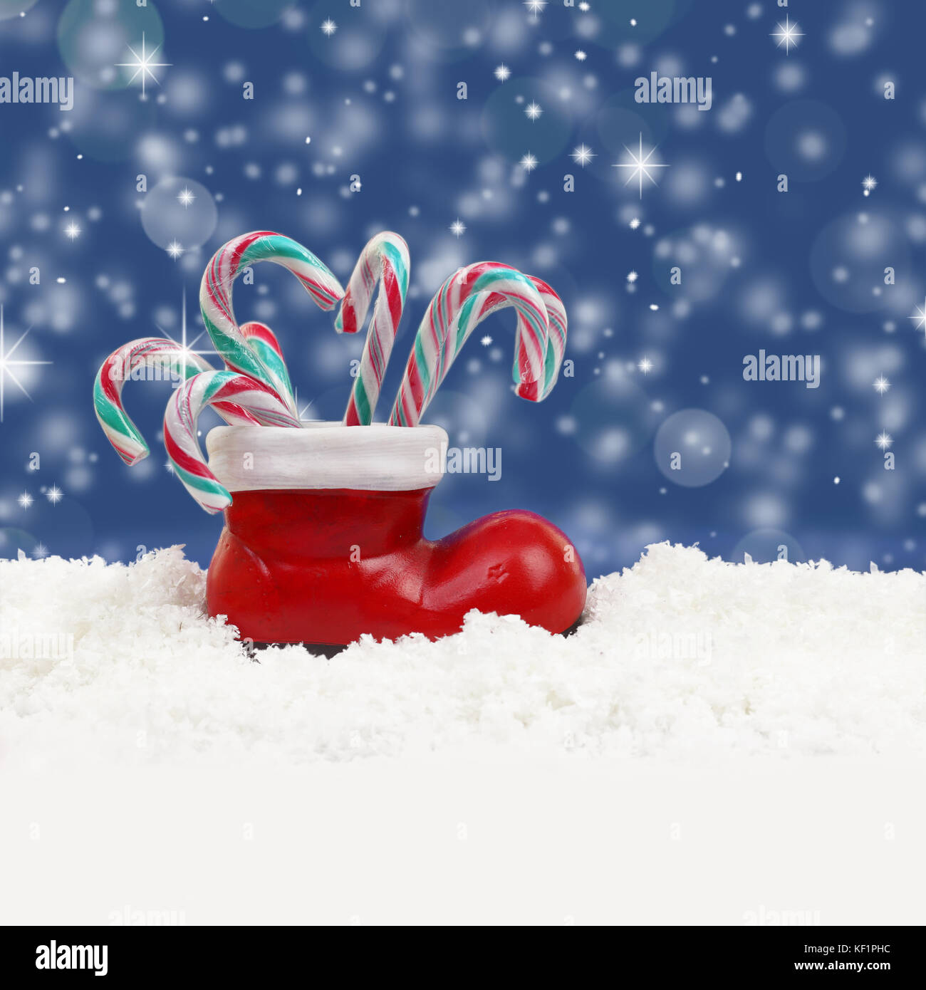 Christmas candy canes in santas boot on snow Stock Photo - Alamy