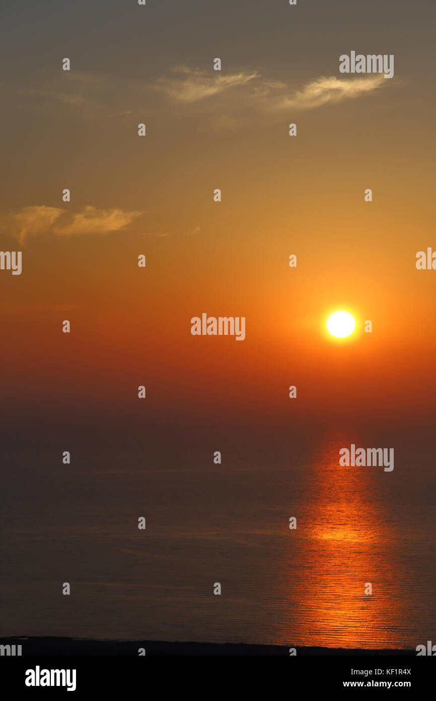 Deep orange color sunset on the beach Stock Photo - Alamy