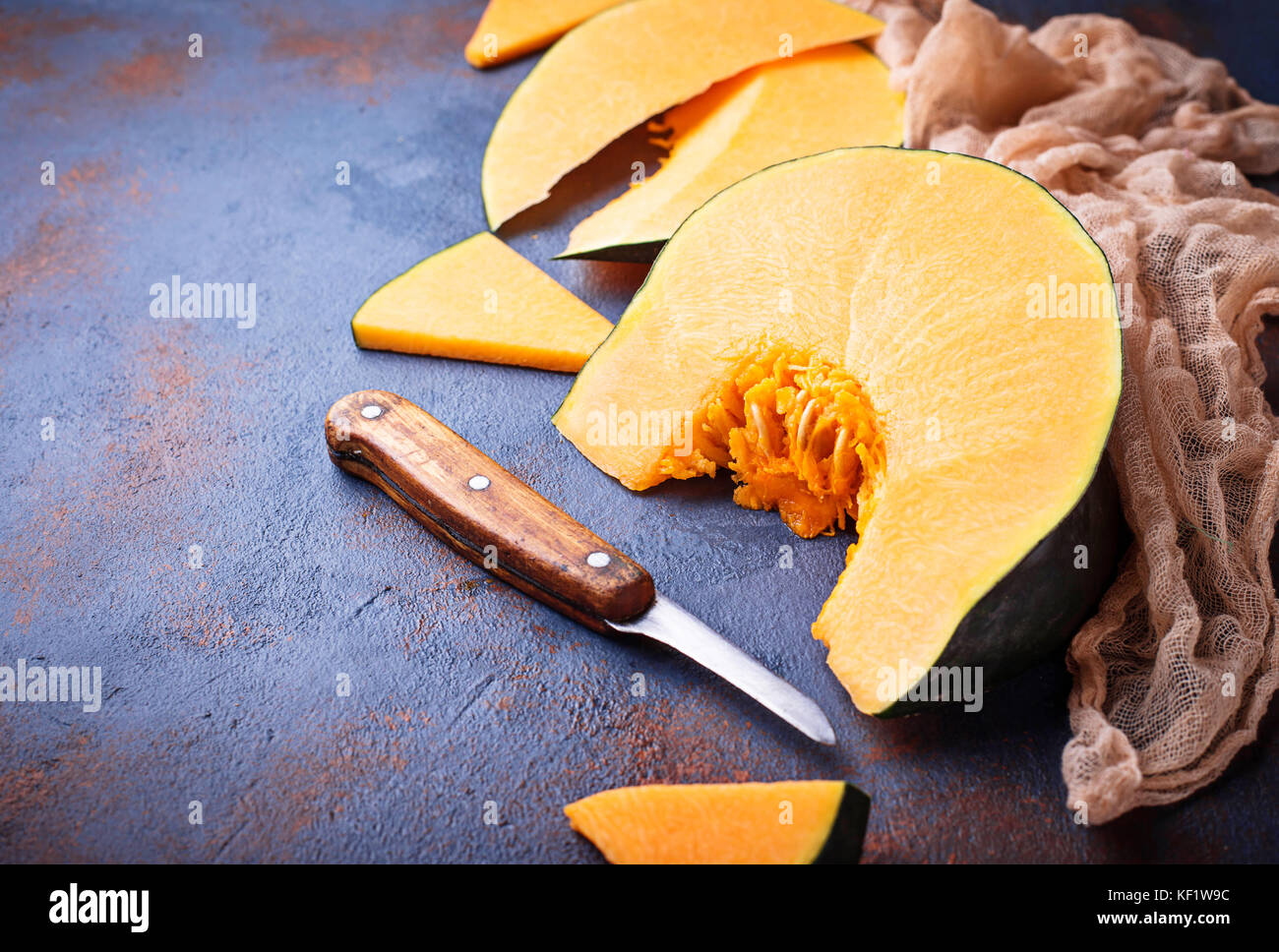 Raw chopped pumpkin on concrete background Stock Photo - Alamy
