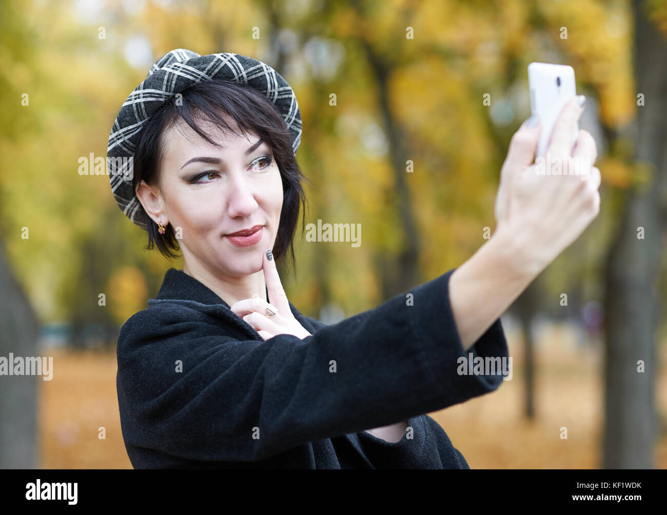 selfie of a girl in autumn city park, yellow leaves and trees, fall ...