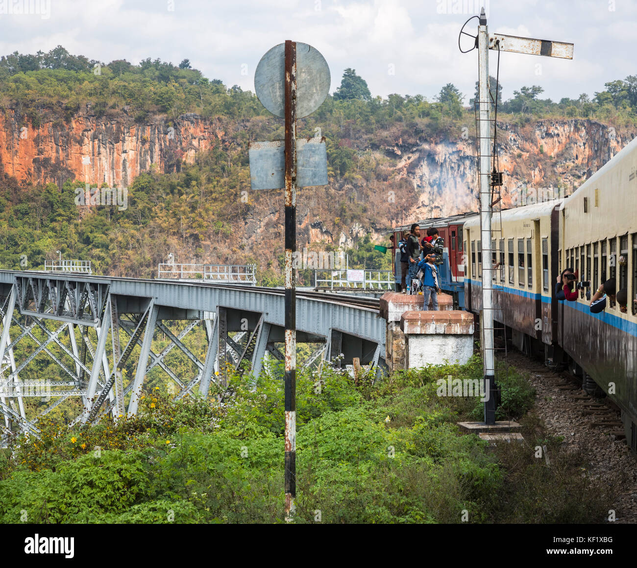 Local people watch the train pass on the Goteik viaduct, a railway ...