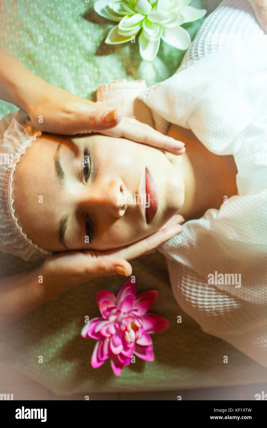 Close-up of a young woman getting spa treatment at beauty salon. spa face massage. facial beauty ...
