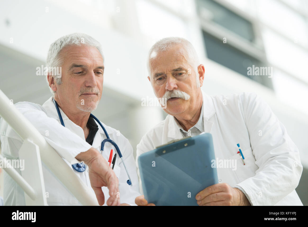 two senior doctors talking together Stock Photo - Alamy