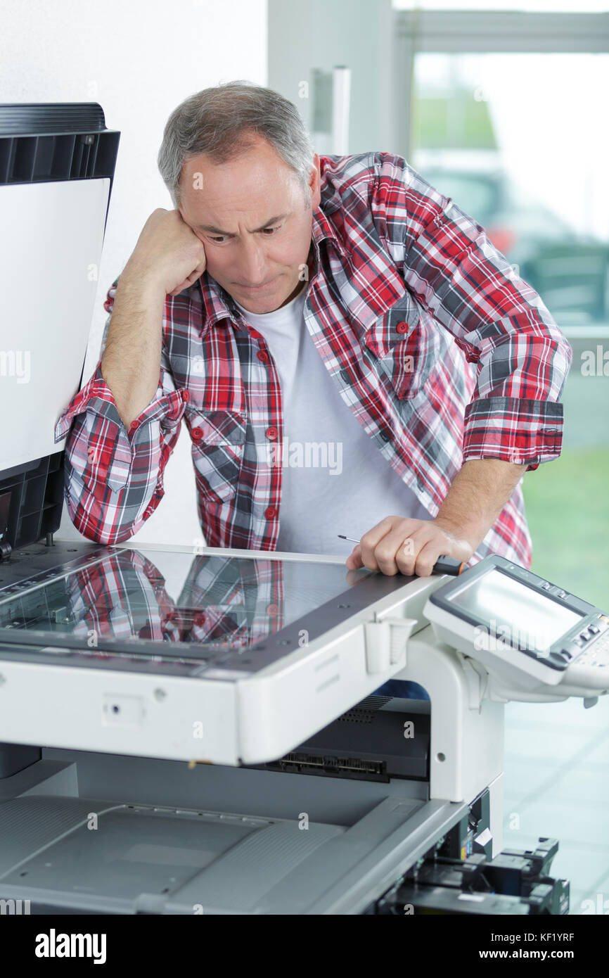 printer checking a print run at table Stock Photo - Alamy