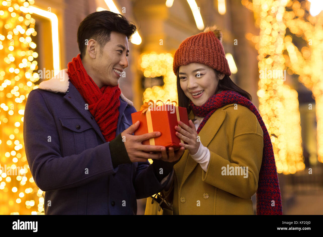 Young men give girlfriend gifts Stock Photo - Alamy