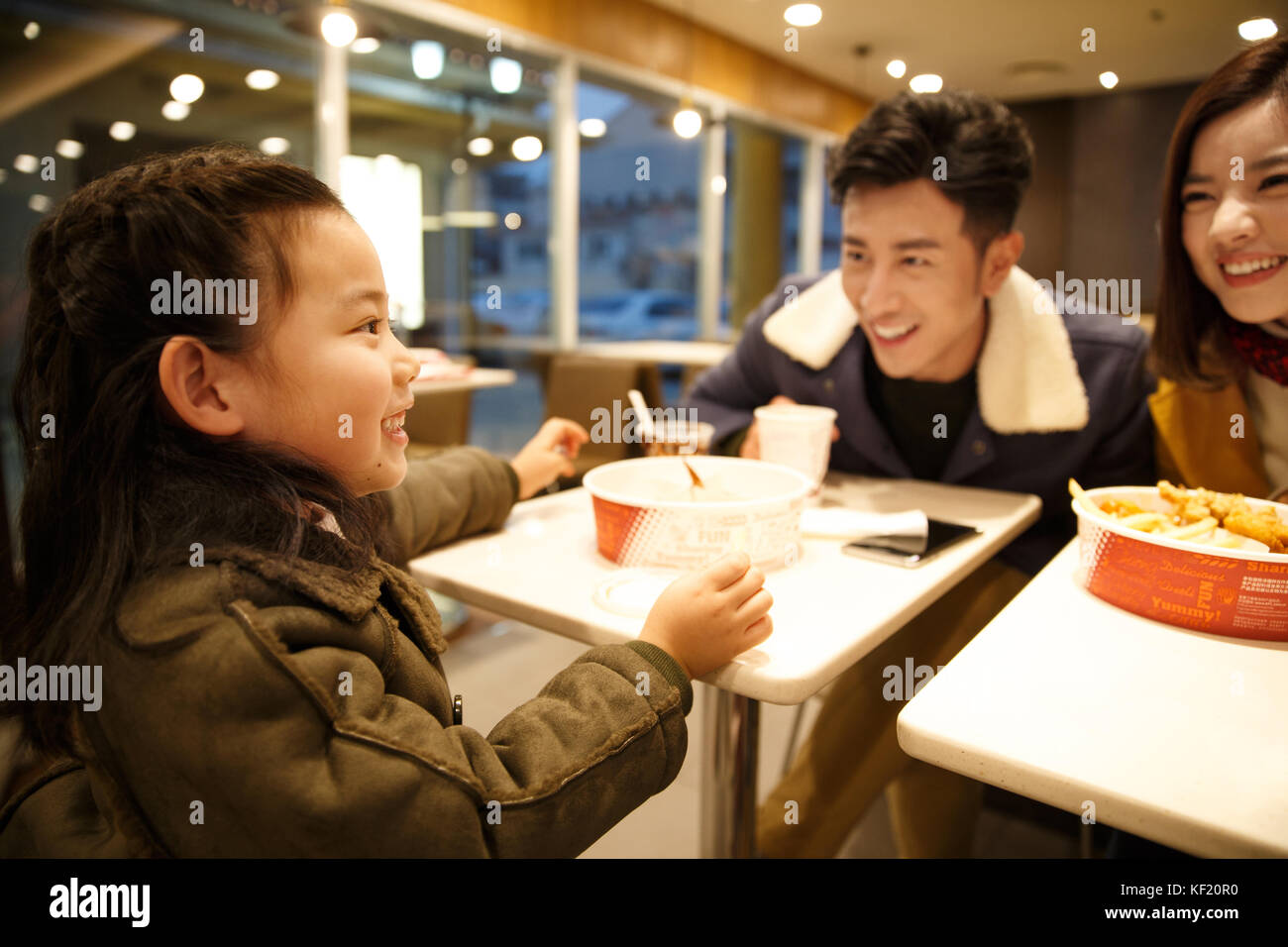 Happy family dining in a restaurant Stock Photo - Alamy
