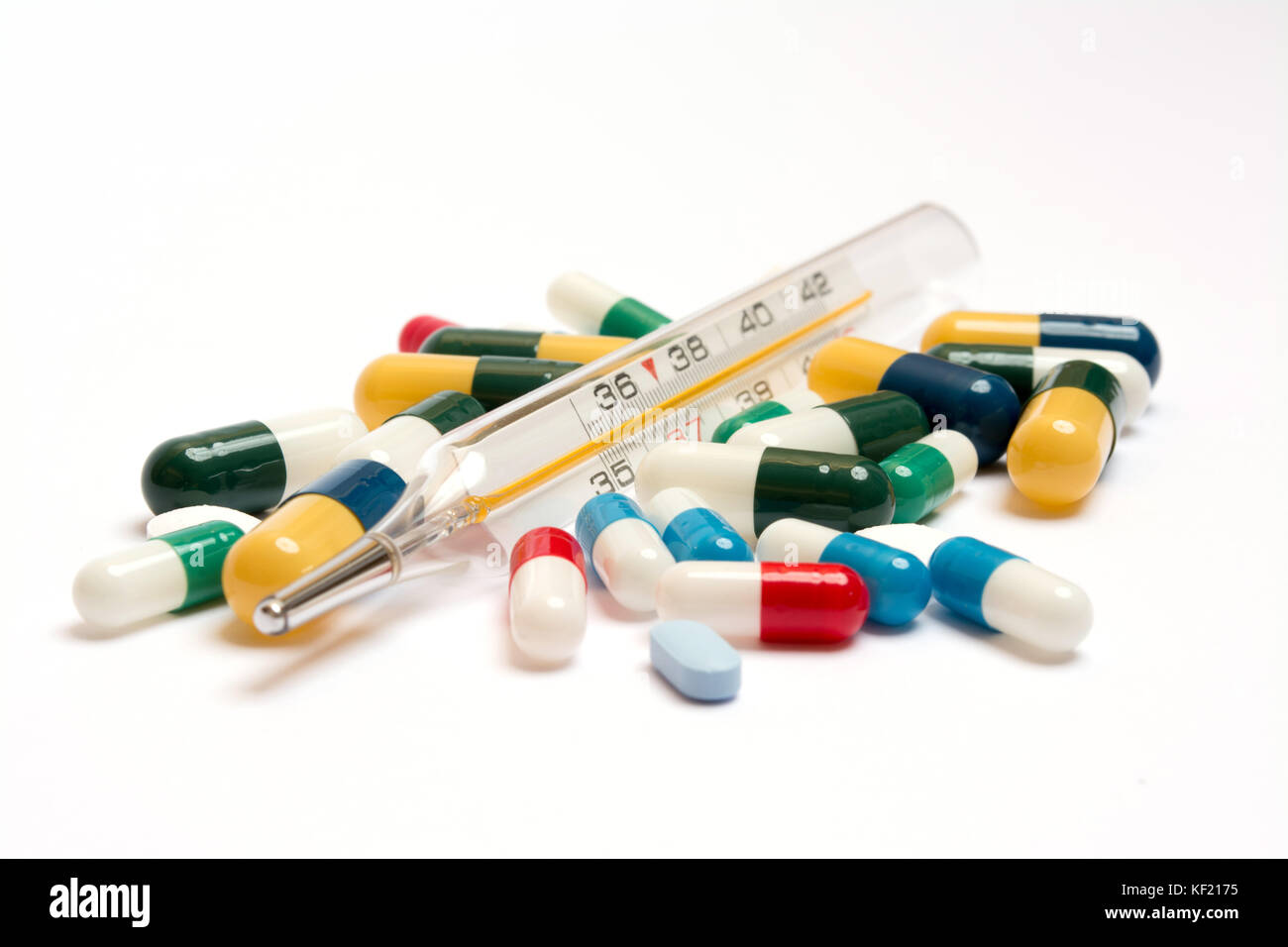 Various pills with thermometer Stock Photo - Alamy