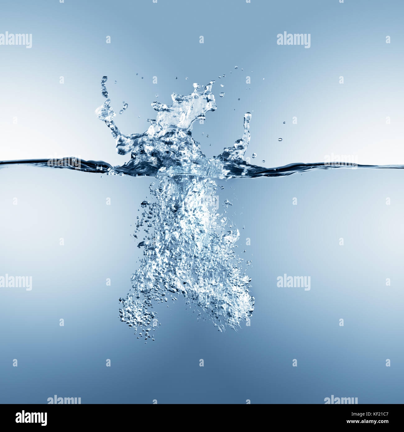 Dramatic blue water splash, water drops and air bubbles on blue grey ...